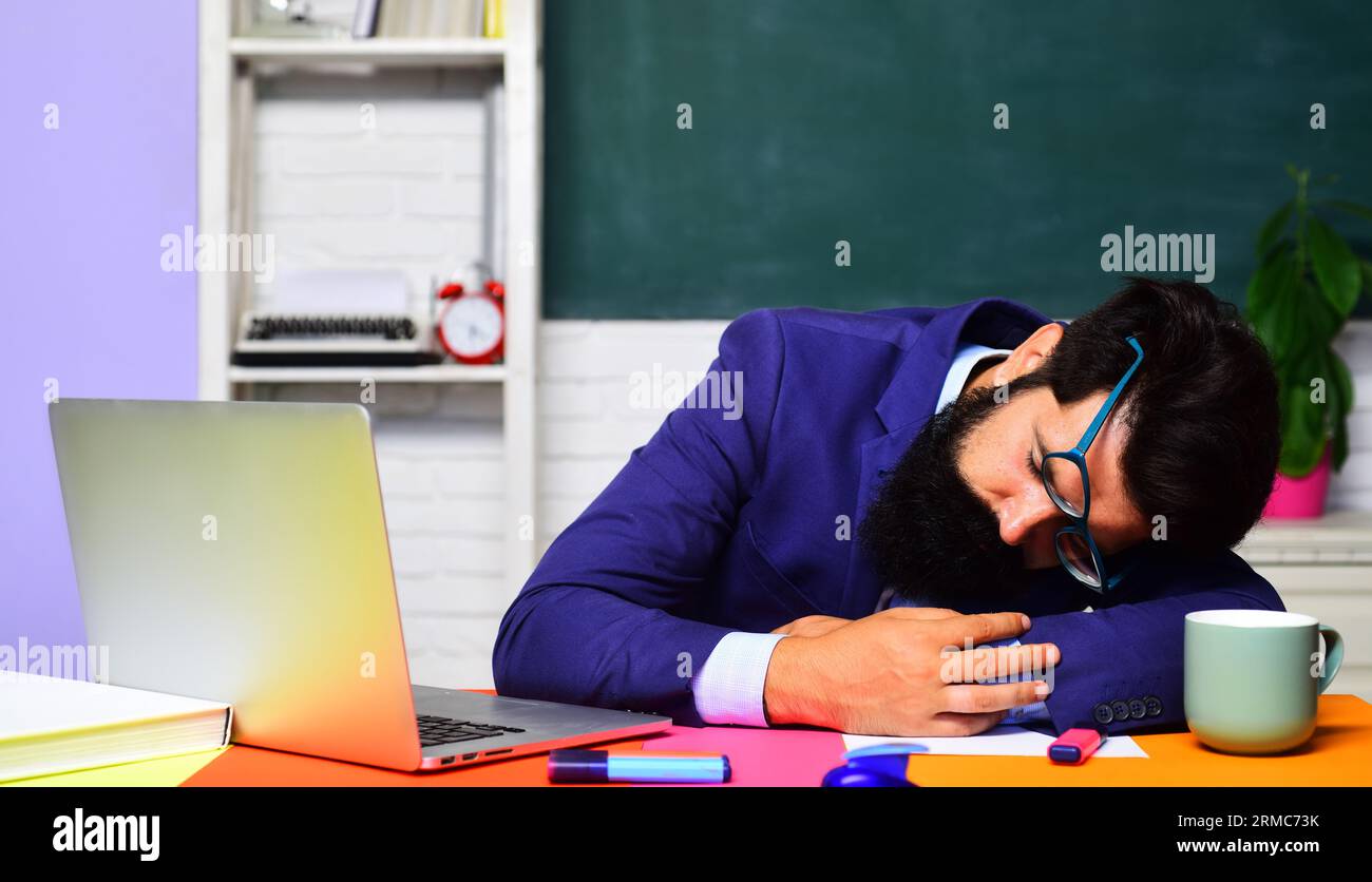 Hard work. School job. Tired male teacher in glasses sleeping at desk ...