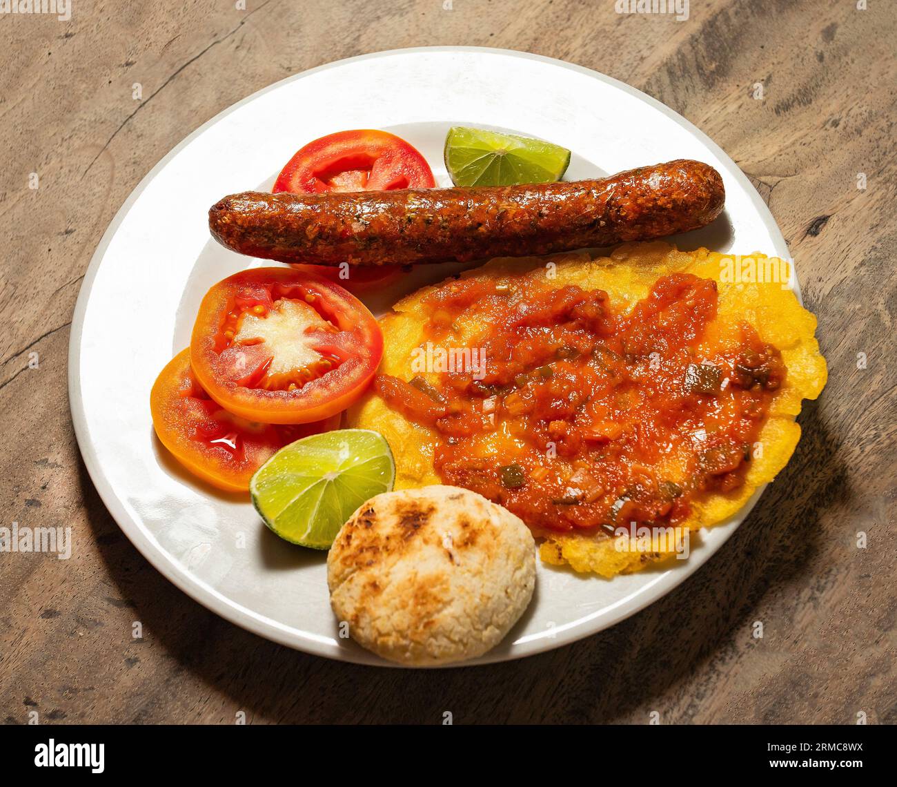 Fried chorizo with patacon and tomatoes - Colombian traditional food ...