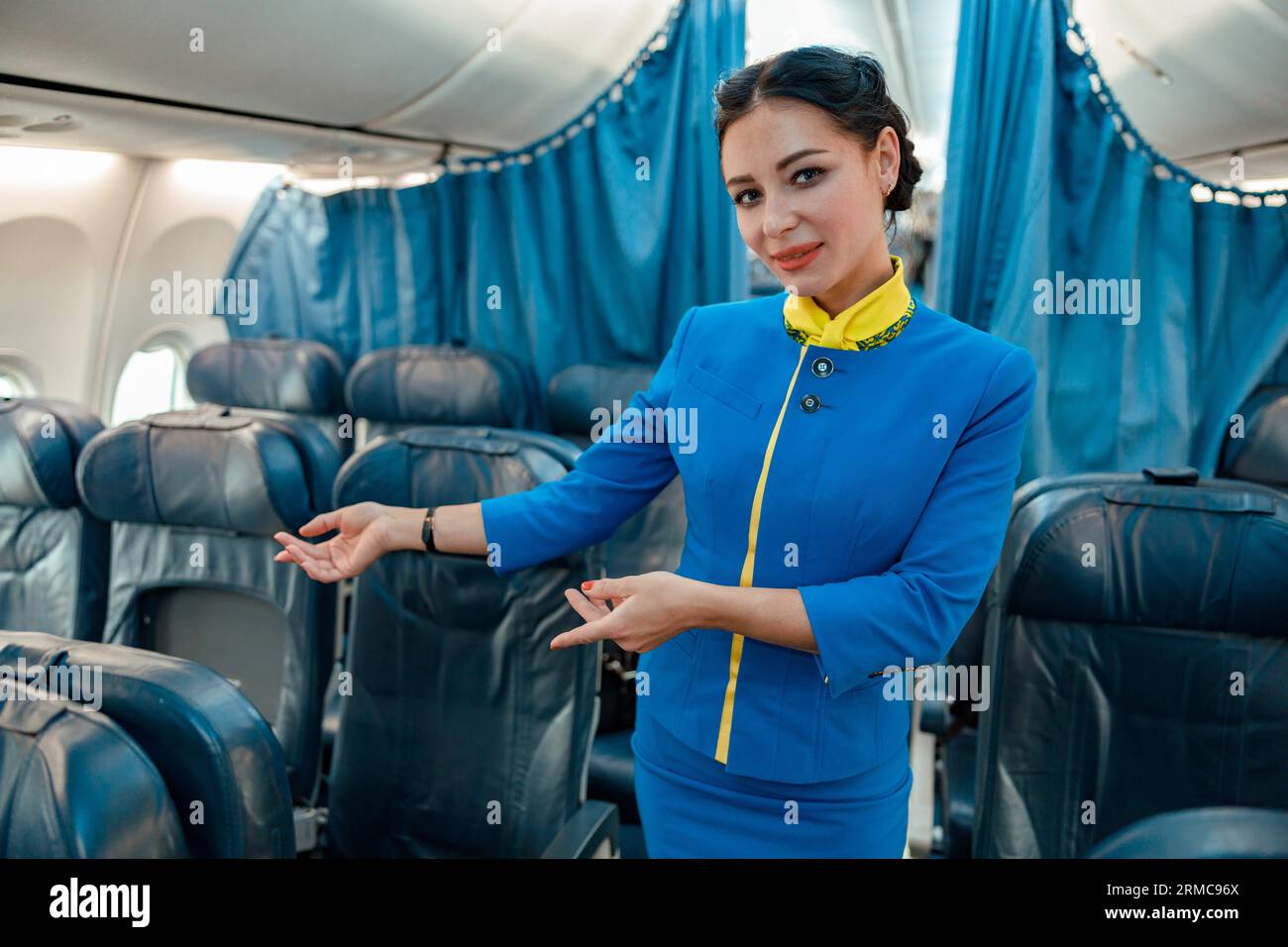 Woman stewardess suggesting hi-res stock photography and images - Alamy