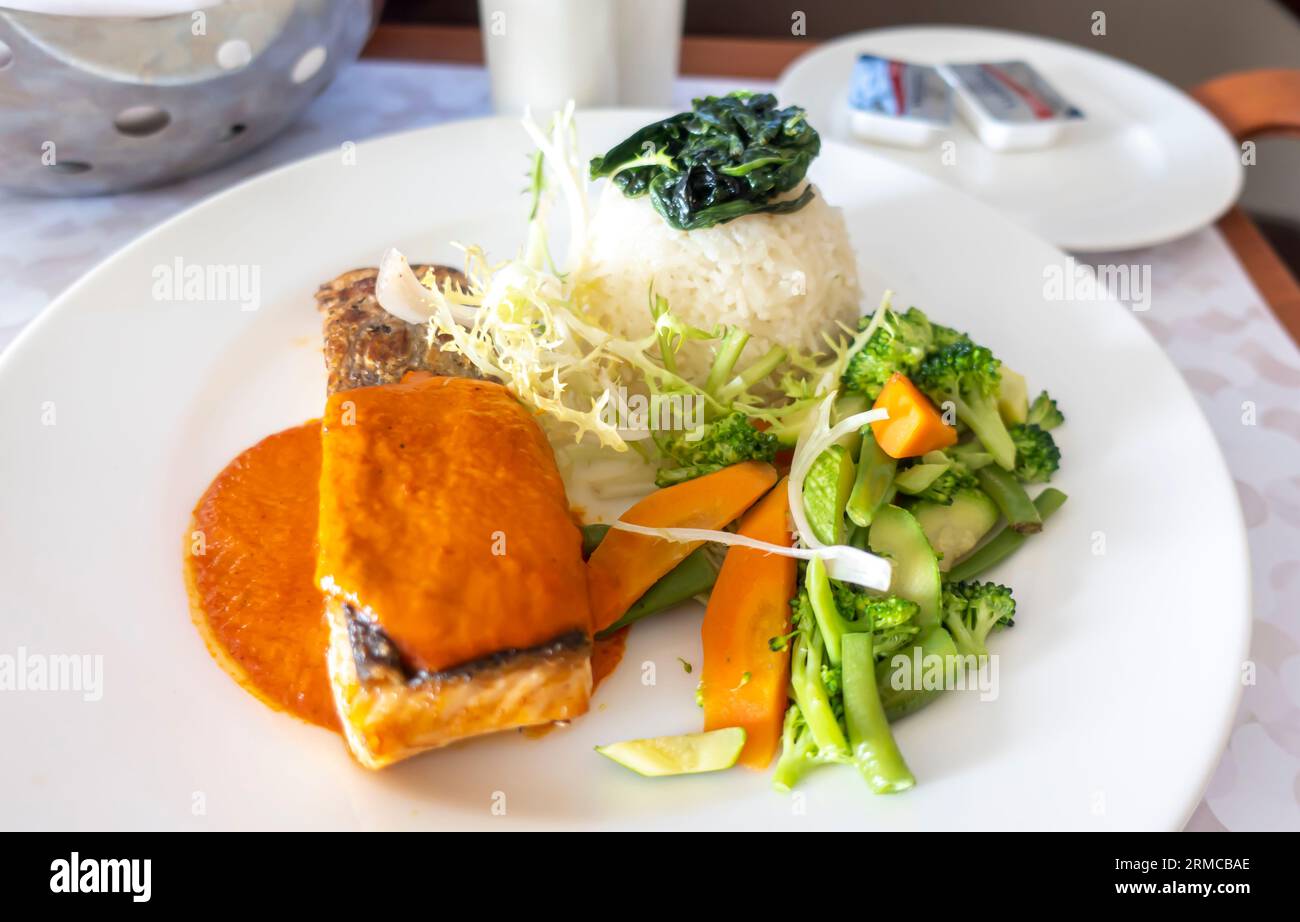 Grilled salmon with rice and vegetables served in room service in ...
