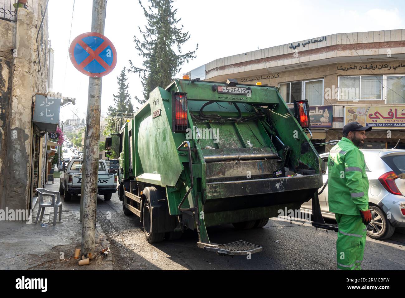 Garbage truck in Amman Jordan, worker in uniform Stock Photo - Alamy