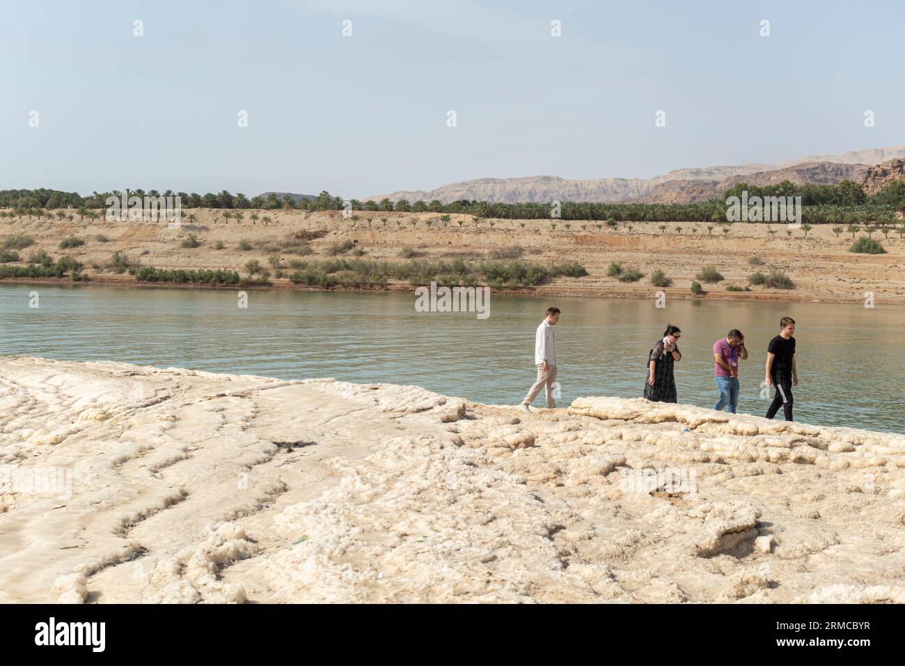 Tourists at Salty rocks tourist attraction on the Dead Sea shore in ...