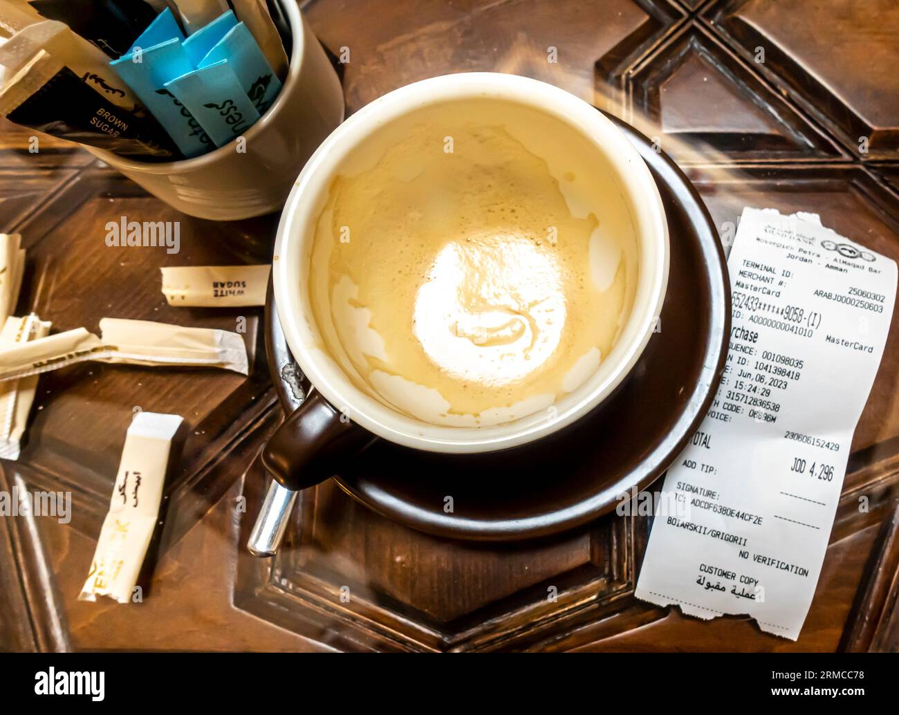 Cup of coffee and the receipt in the lobby cafe bar in Mövenpick Petra ...