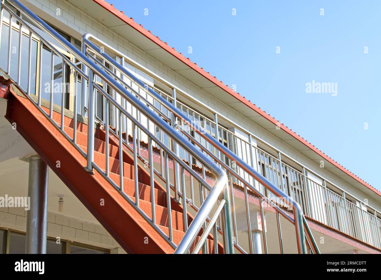 Metal railings on both sides of the stairs, in a building Stock Photo ...