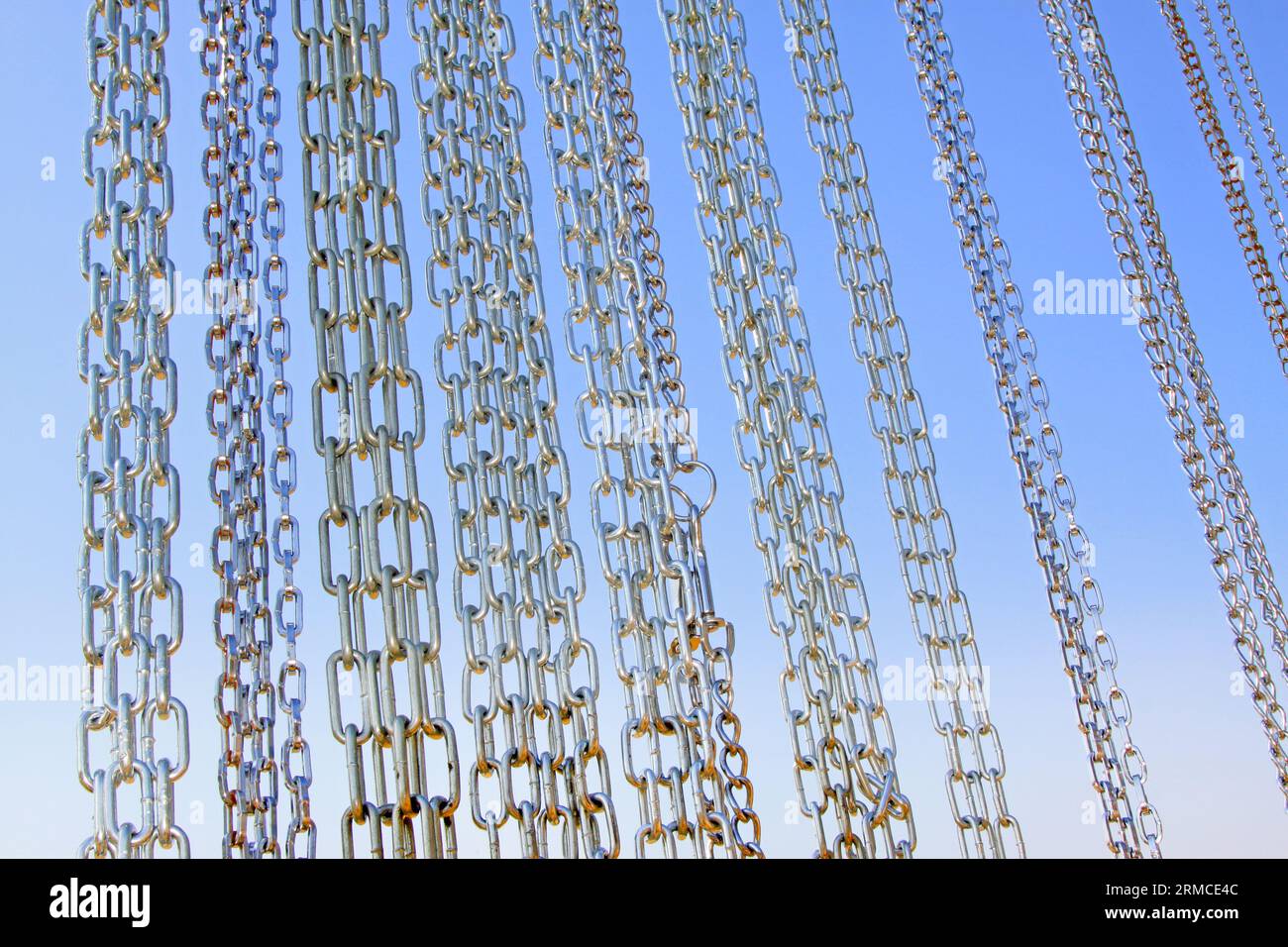 Stainless steel chains on blue sky background, in a market Stock Photo ...