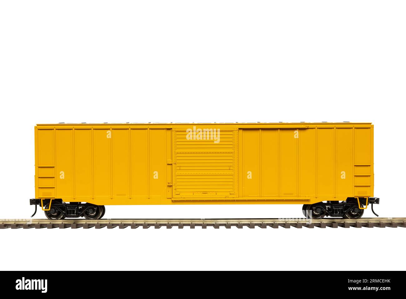 A yellow railroad boxcar on railroad track Stock Photo - Alamy