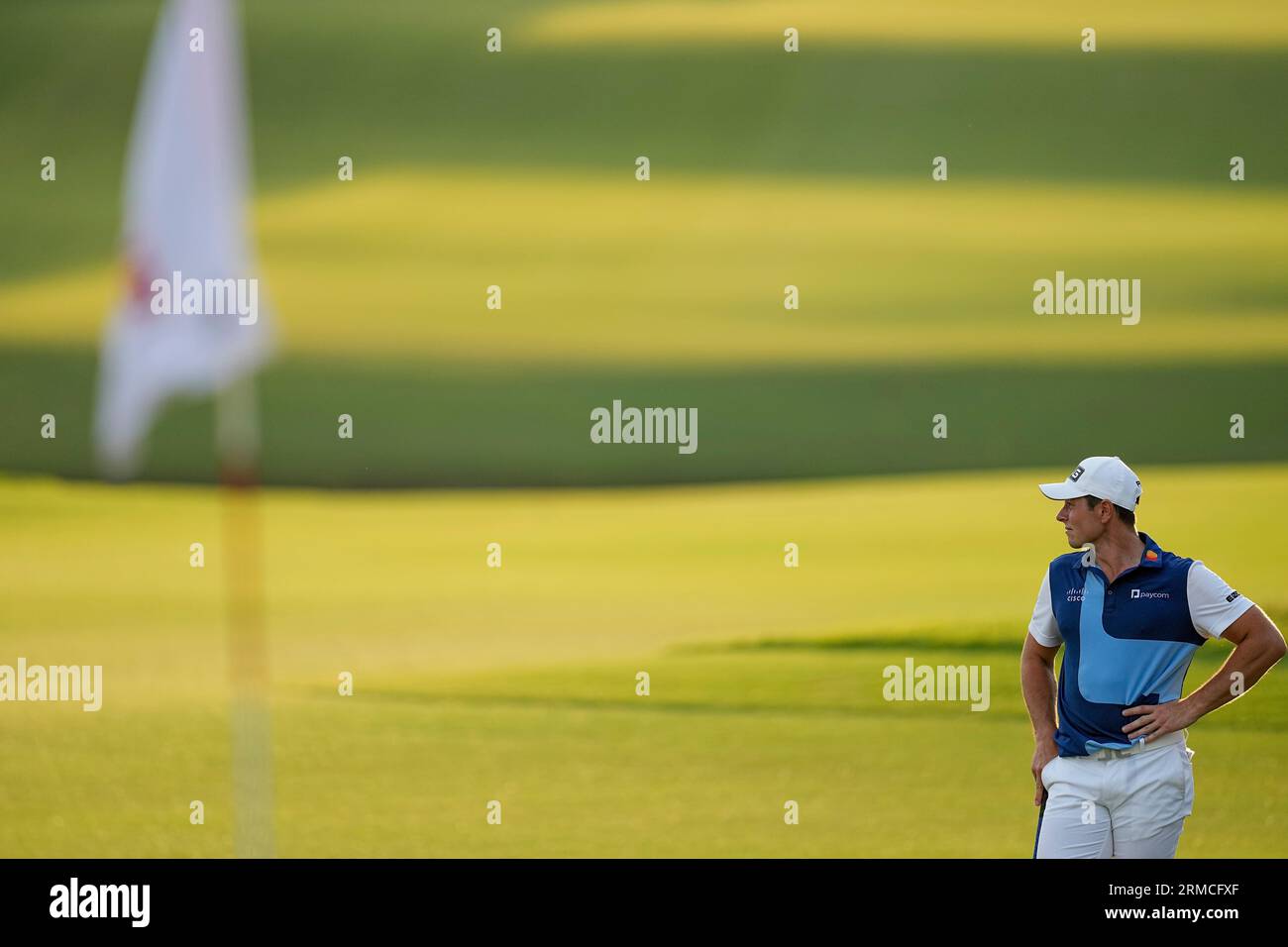 Viktor Hovland, of Norway, stands on the 18th fairway during the final ...