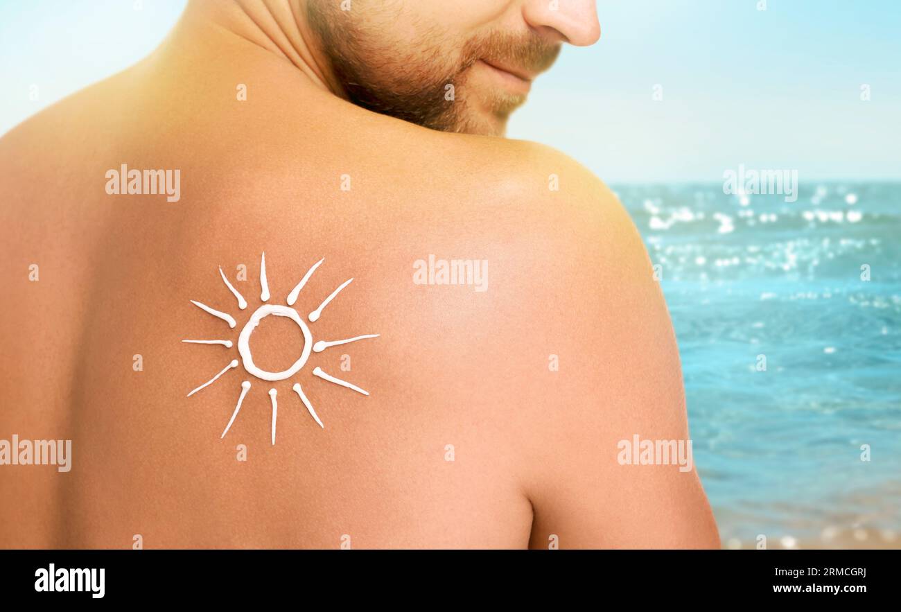 Sun protection. Man with sunblock on his back near sea, closeup Stock ...