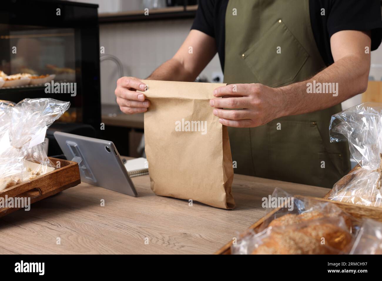 Cashier paper bag hi-res stock photography and images - Alamy