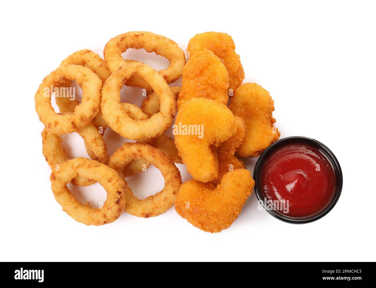 Tasty fried onion rings, chicken nuggets and ketchup on white ...