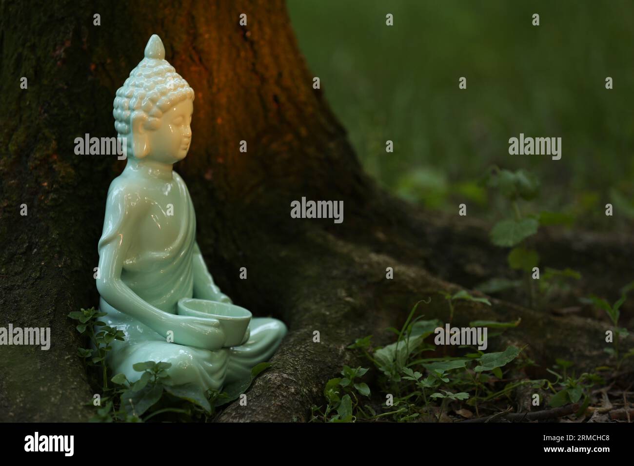 Decorative Buddha statue near tree outdoors, space for text Stock Photo ...