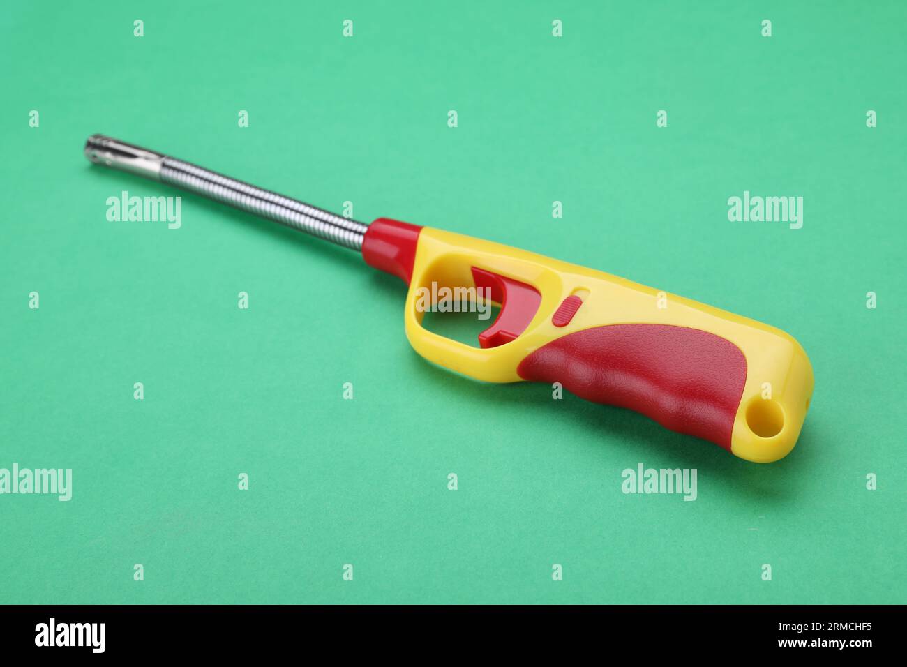 One bright gas lighter on green background Stock Photo - Alamy