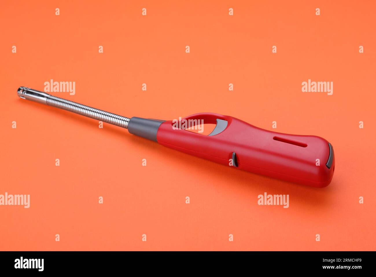 One bright gas lighter on orange background Stock Photo - Alamy
