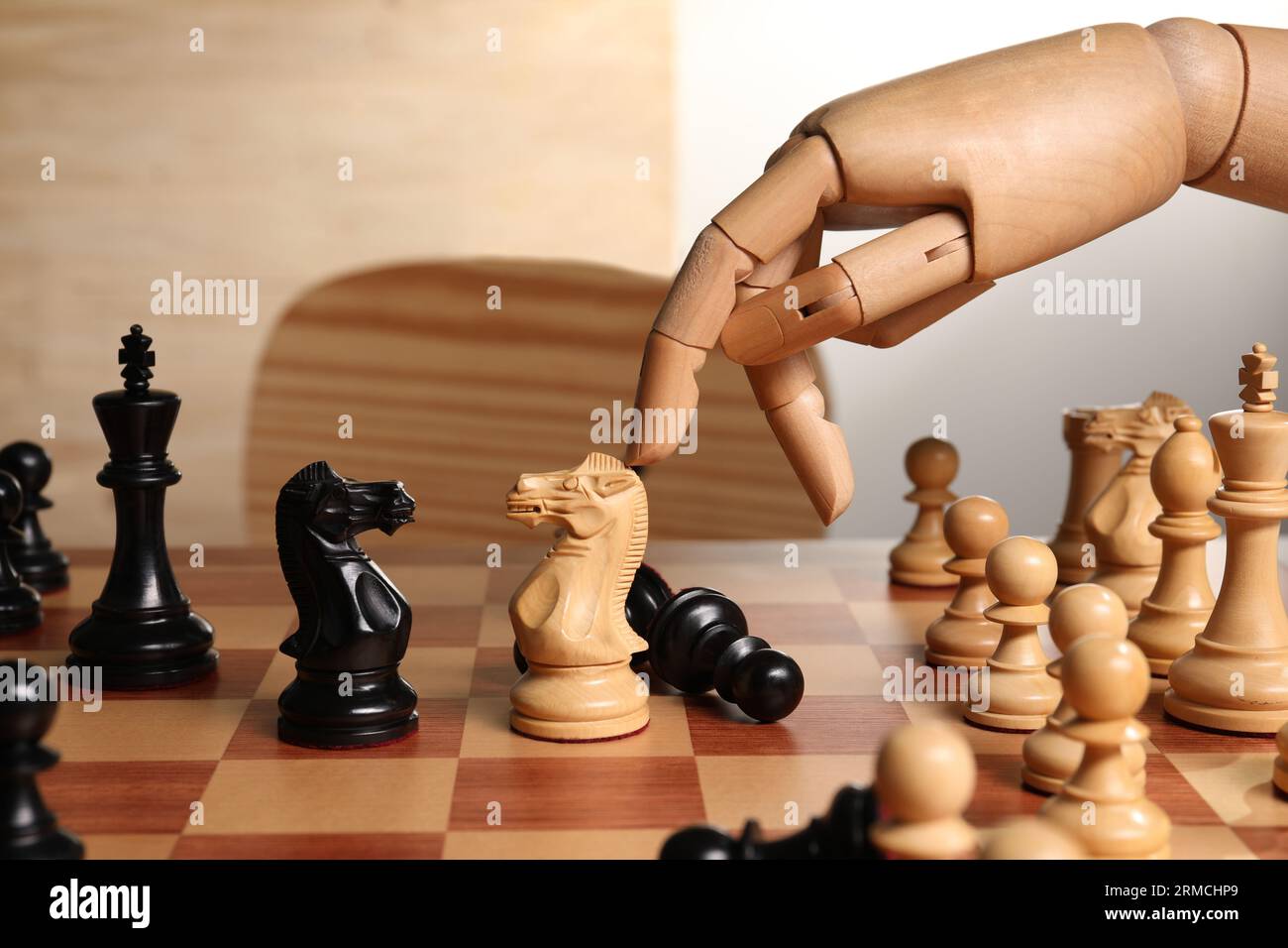 Robot moving chess piece on board, closeup. Wooden hand representing ...