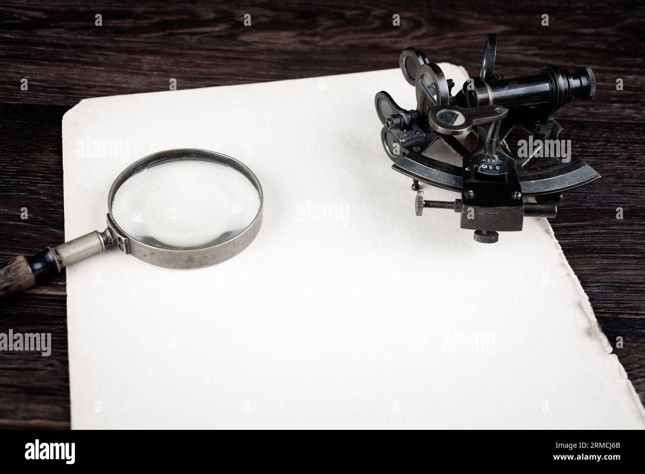Antique bronze sextant on old paper background Stock Photo - Alamy