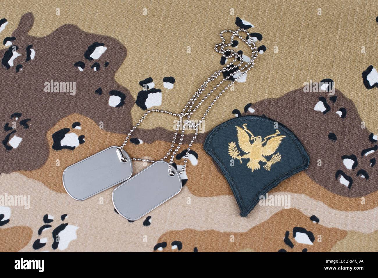 US ARMY Specialist rank patch and dog tags on desert camouflage uniform ...