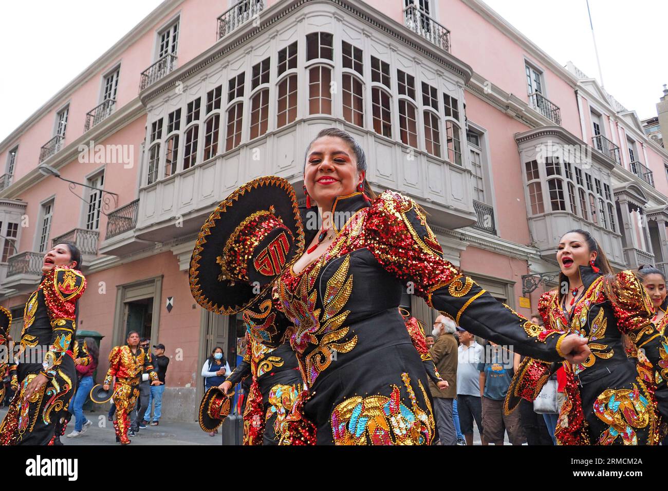 Troupe of women performing a dance and wearing traditional costumes ...