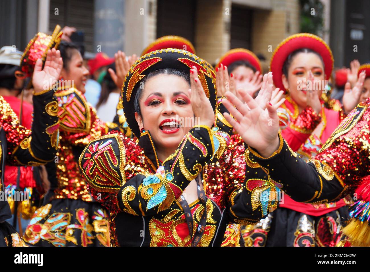 Troupe of women performing a dance and wearing traditional costumes ...
