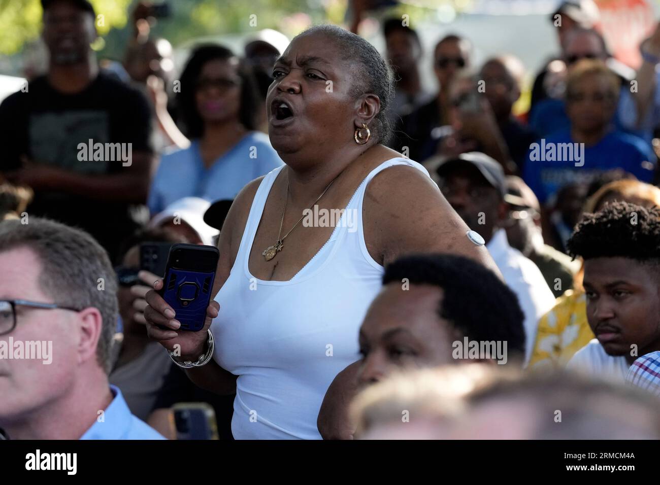 A local resident shouts as Florida Gov. Ron DeSantis makes remarks ...