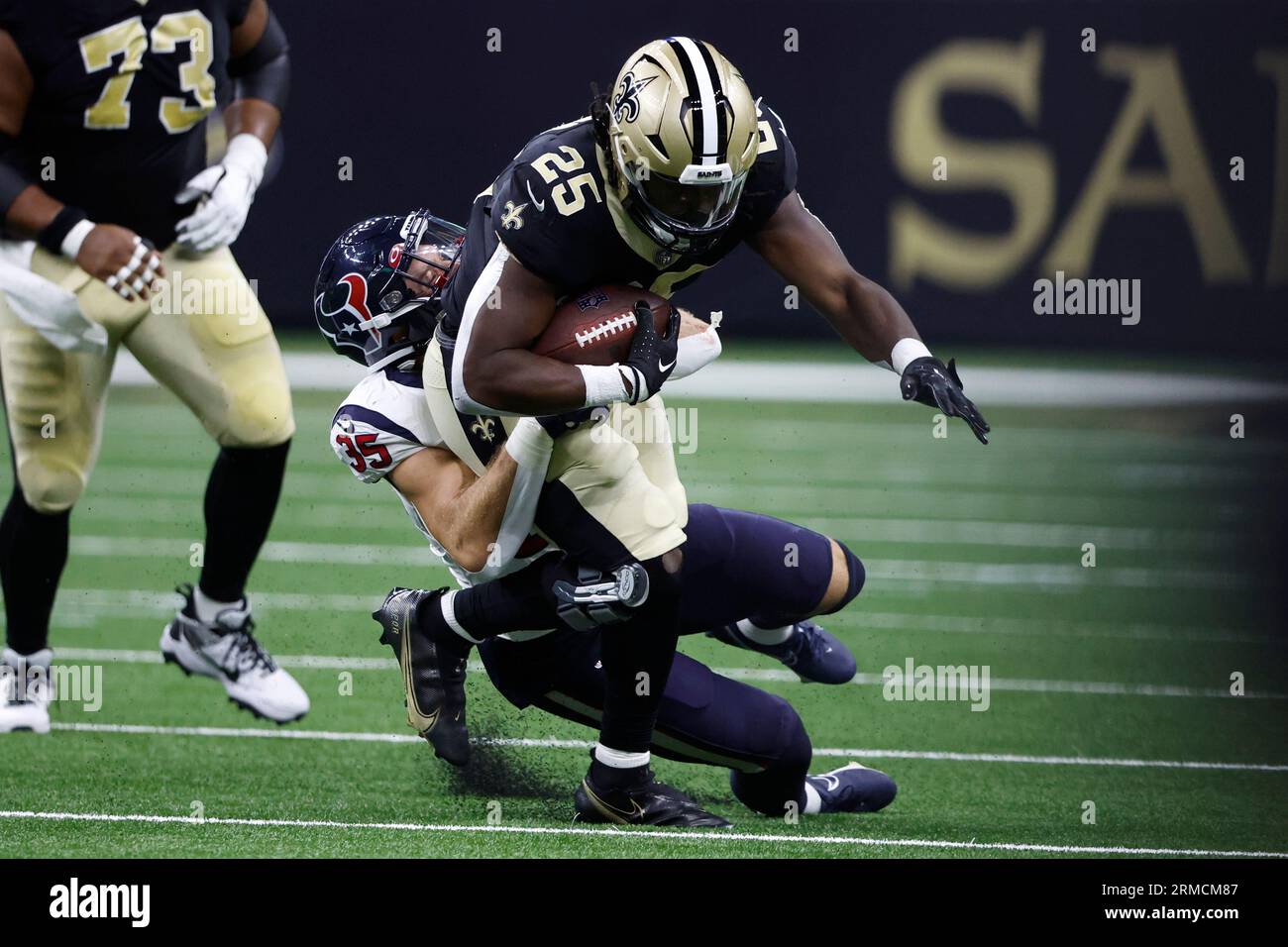 New Orleans Saints running back Kendre Miller (25) is tackled by ...