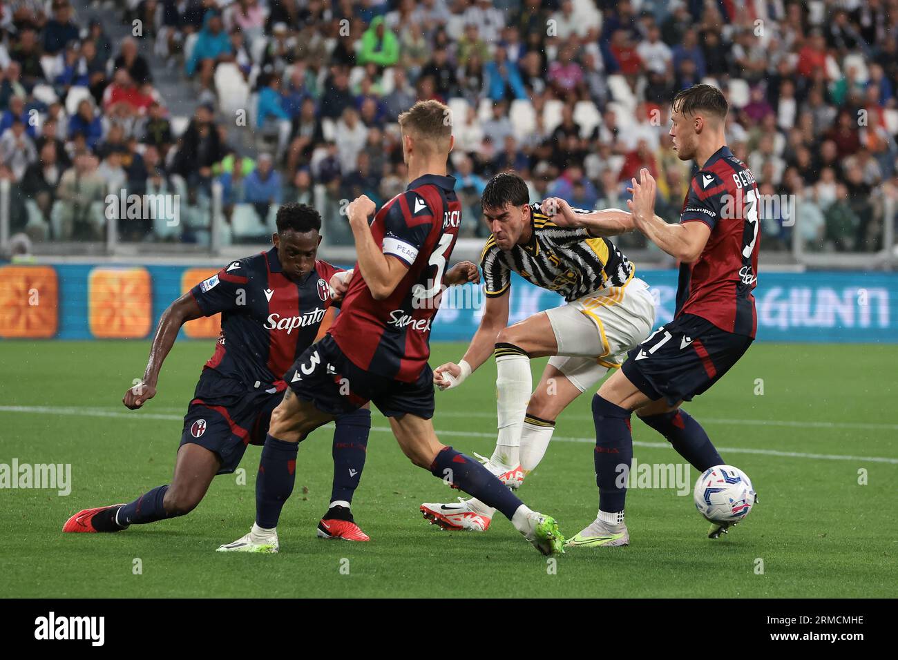 Turin, Italy. 27th Aug, 2023. Dusan Vlahovic of Juventus is smothered ...