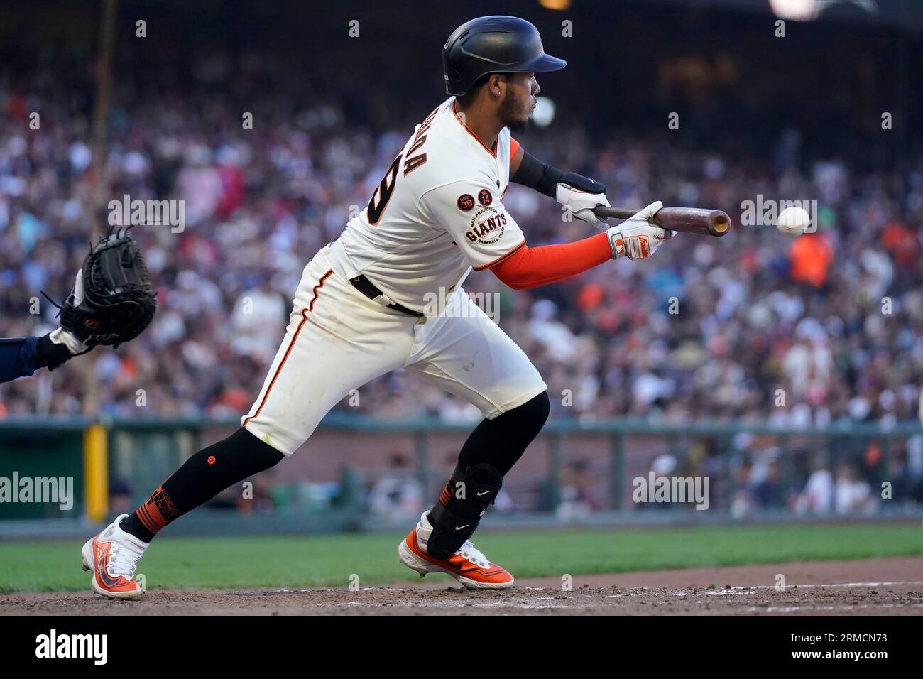San Francisco Giants' Thairo Estrada bunts for an RBI single during the sixth inning of a ...