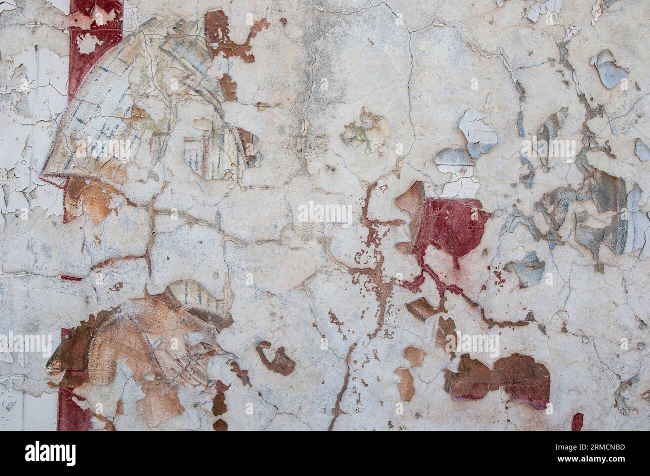 a crumbling wall mural cream and red color palette Stock Photo - Alamy