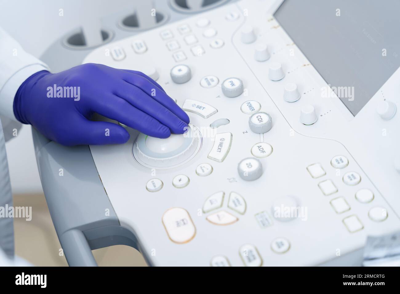 Hand of professional doctor sonographer pushing buttons on ultrasound ...