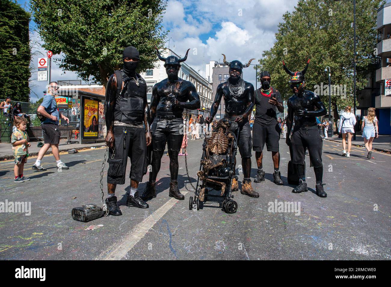 Black painted men pose for a photo. It used to be oil but they replaced ...