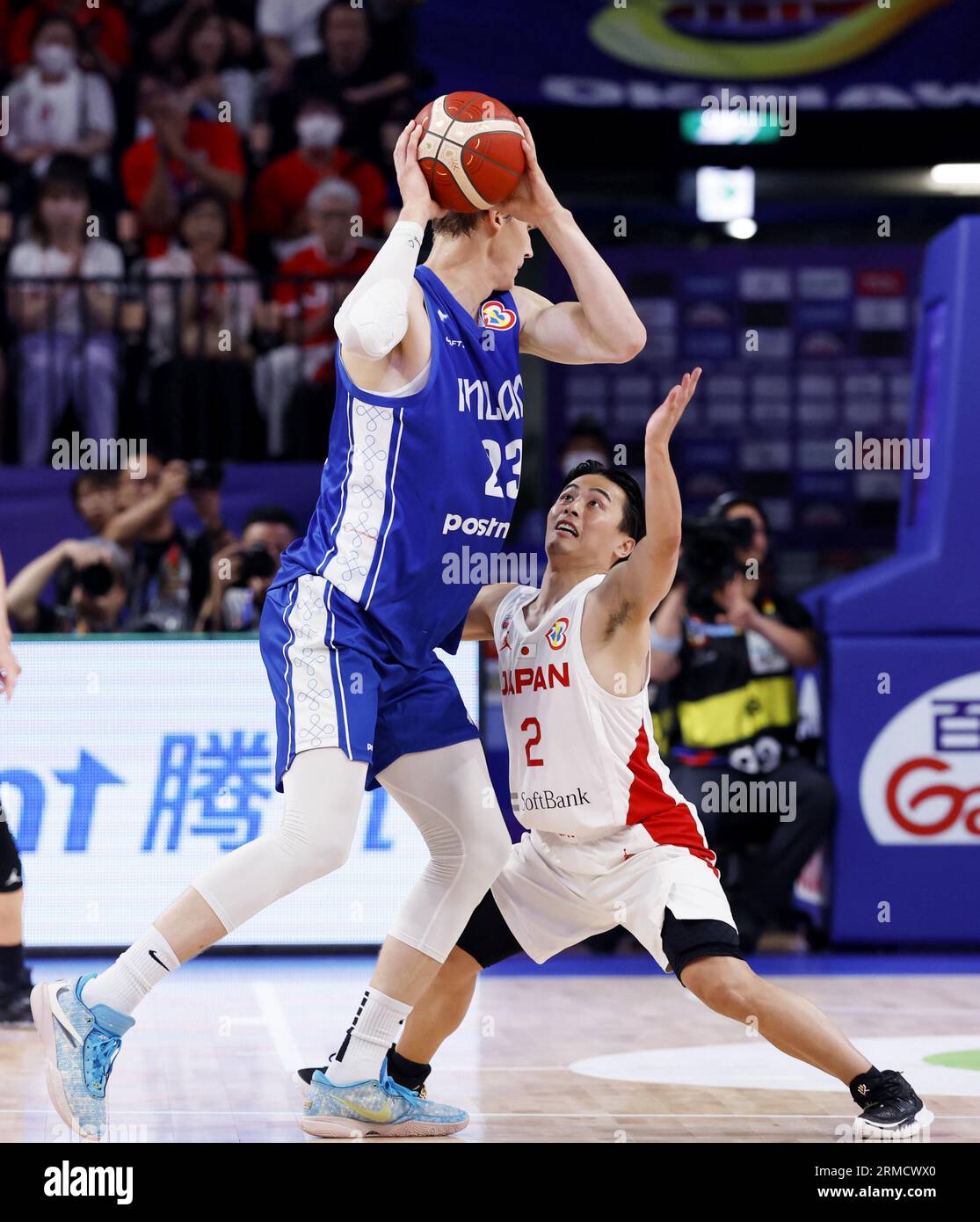 Japan's Yuki Togashi (R) puts defensive pressure on Finland's Lauri Markkanen during the second ...