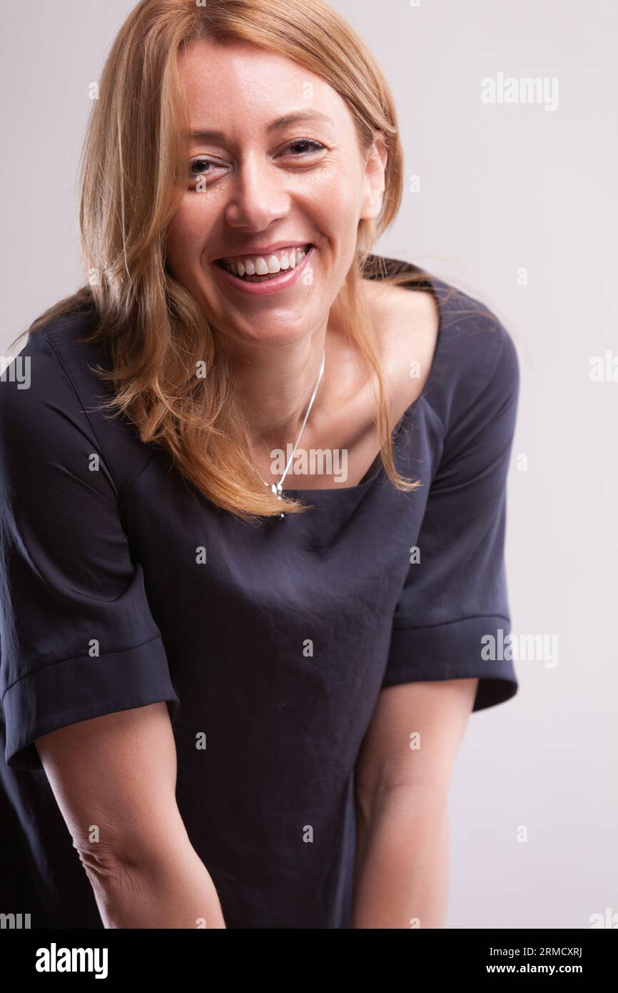 Serene woman, fulfilled with her life's tapestry, smiles broadly. Her ...