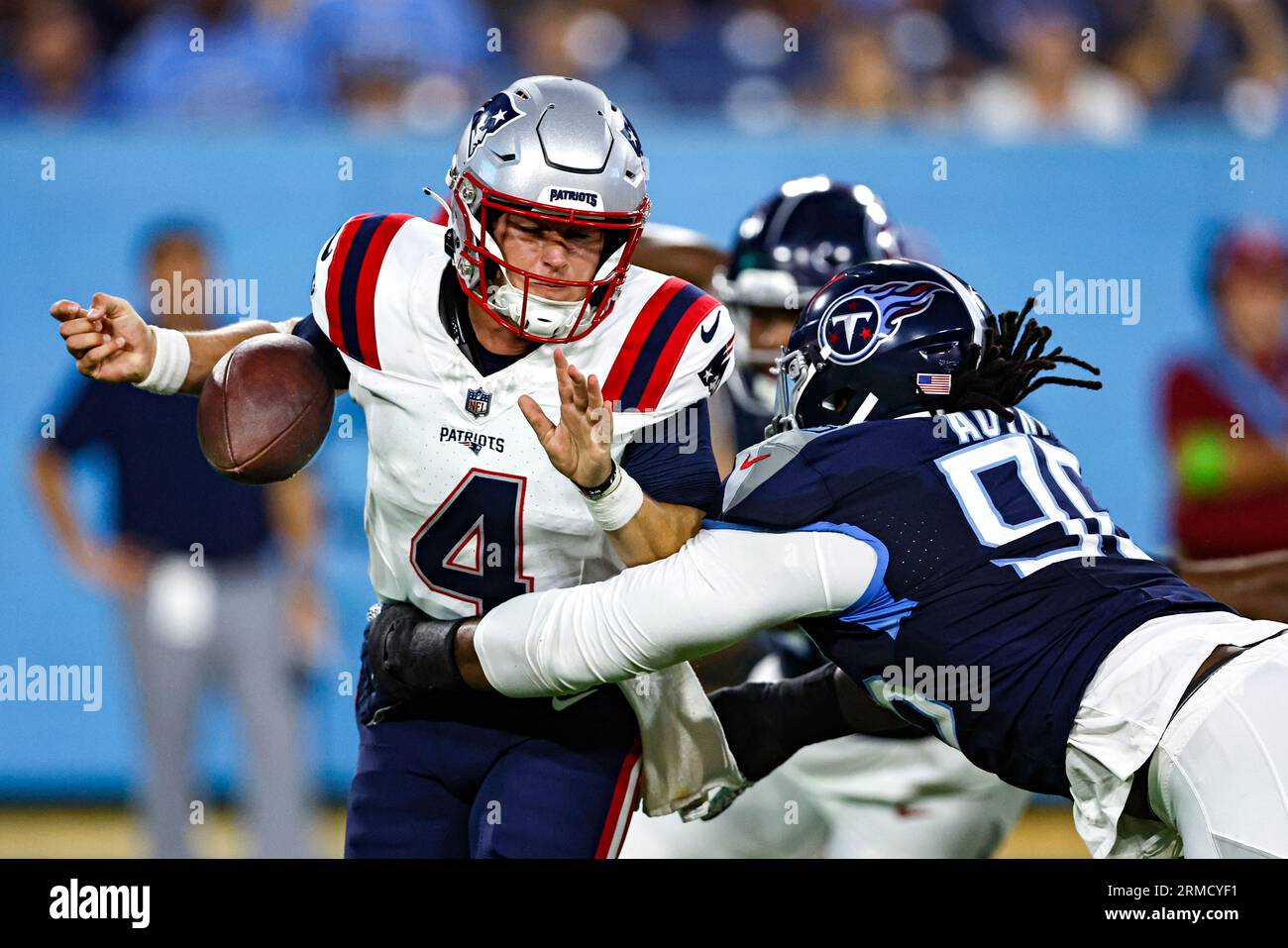New England Patriots quarterback Bailey Zappe (4) has the ball stripped ...