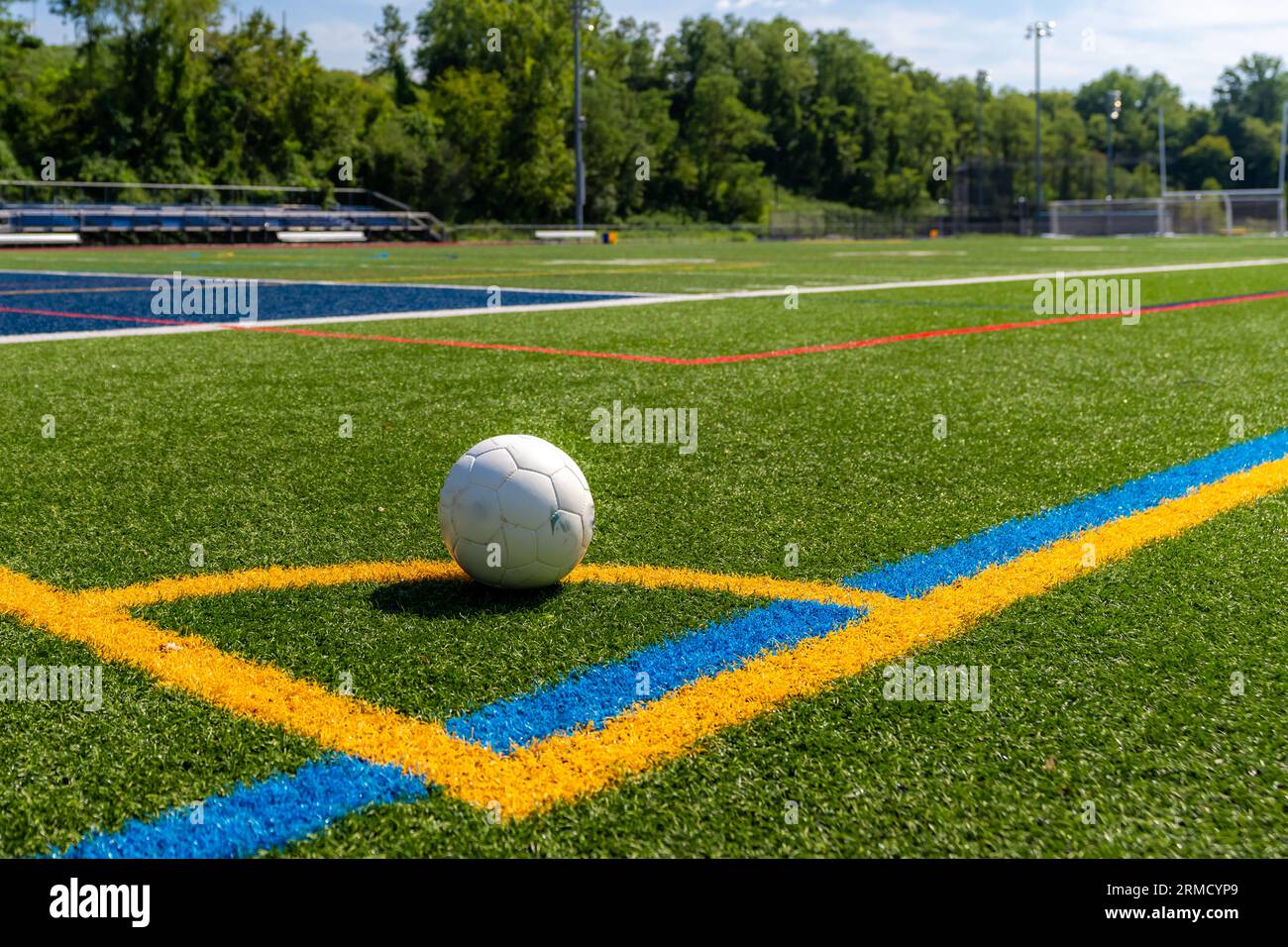 Afternoon photo of a white American soccer ball at the corner of a ...
