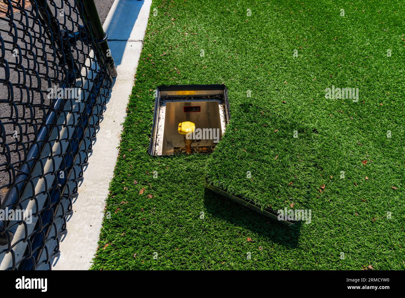 Quick connect hose hookup within a synthetic turf, grass, utility ...