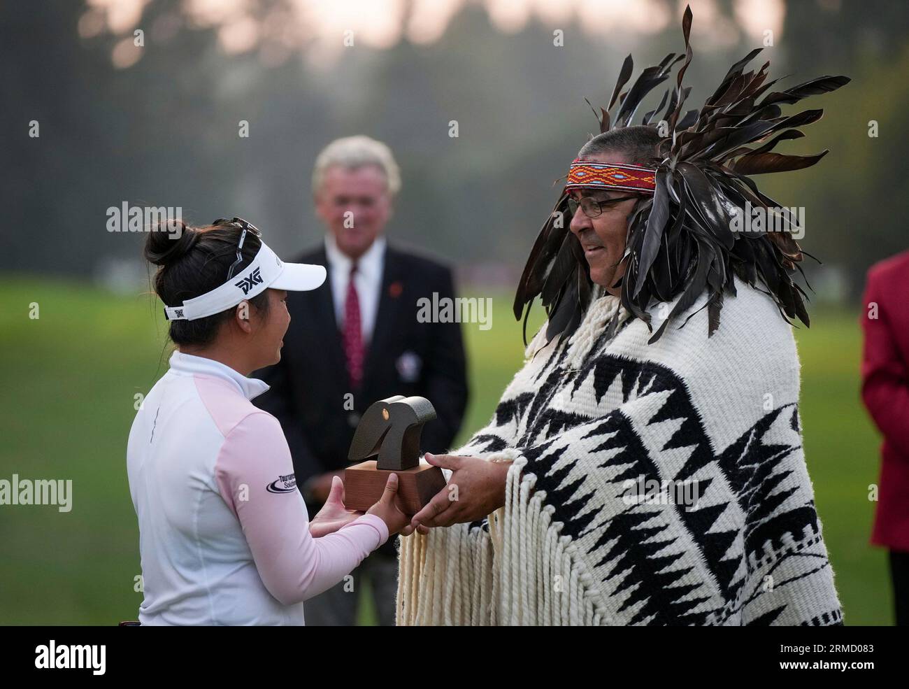 Megan Khang, left, of the United States, receives a carving from ...