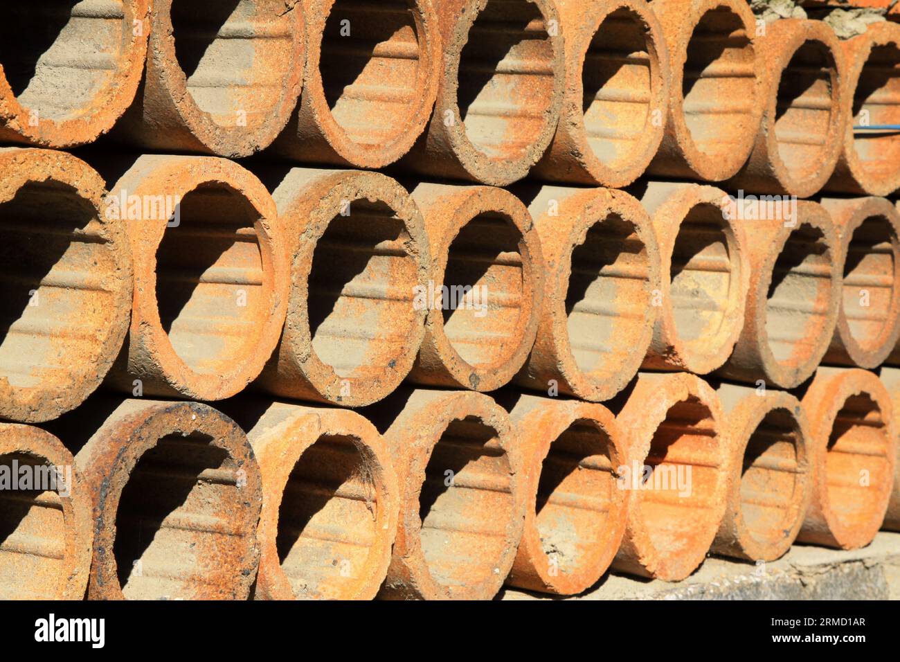 clay drain pipe stacked together in a warehouse Stock Photo - Alamy