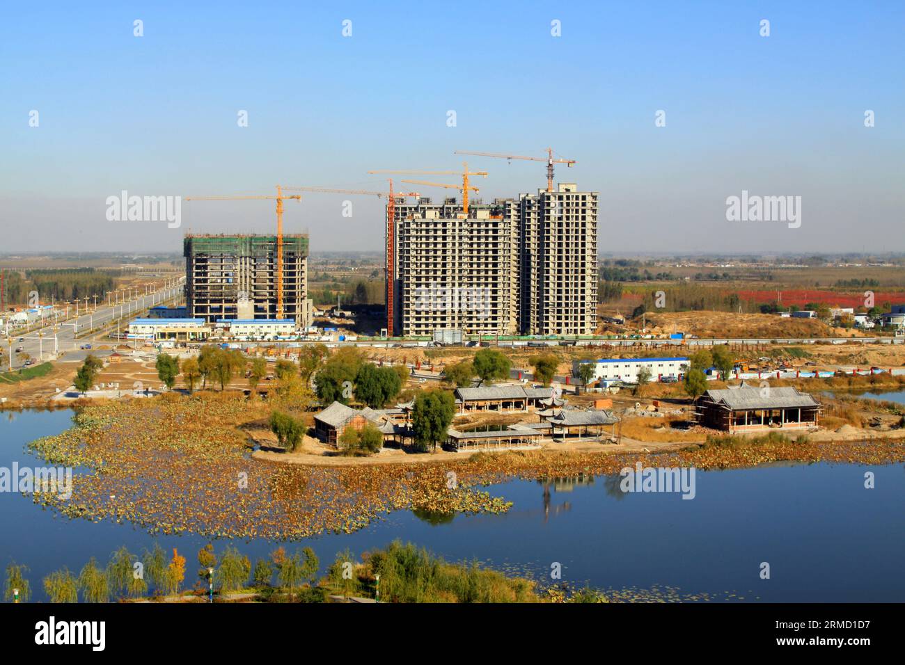 unfinished building by the water in China Stock Photo - Alamy