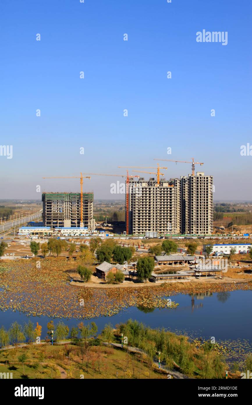 unfinished building by the water in China Stock Photo - Alamy