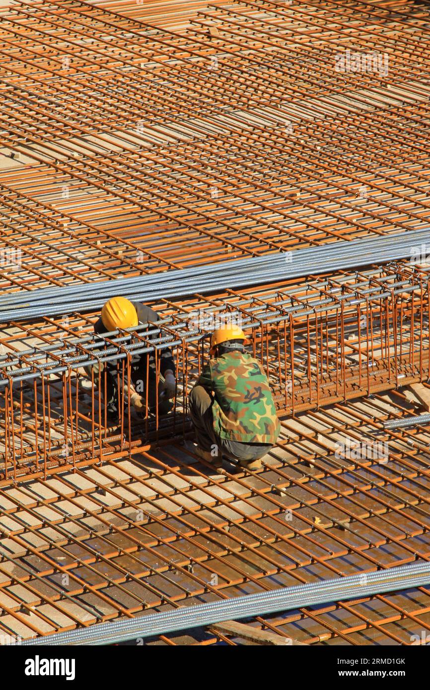 binding steel workers in construction sites in Luannan, Hebei, China ...