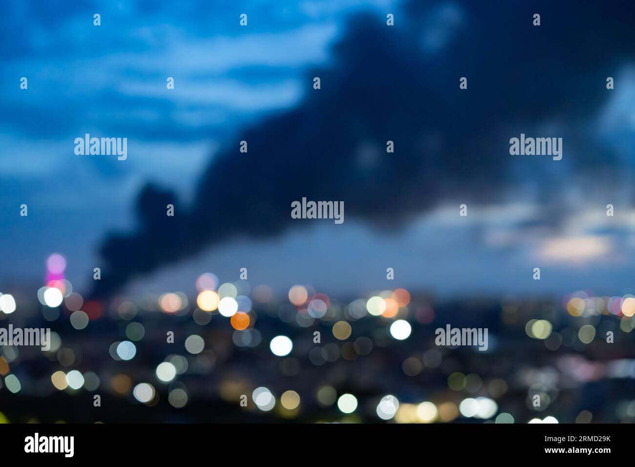 defocused background of factory catched a fire with lots dark smoke in ...