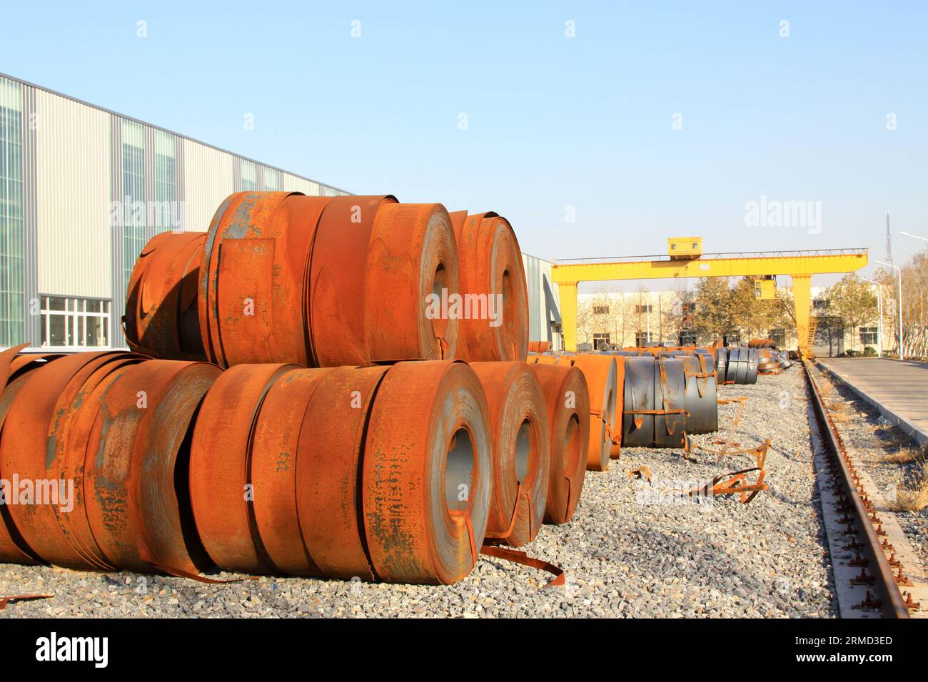 raw materials strip steel and crane, in a material field Stock Photo ...