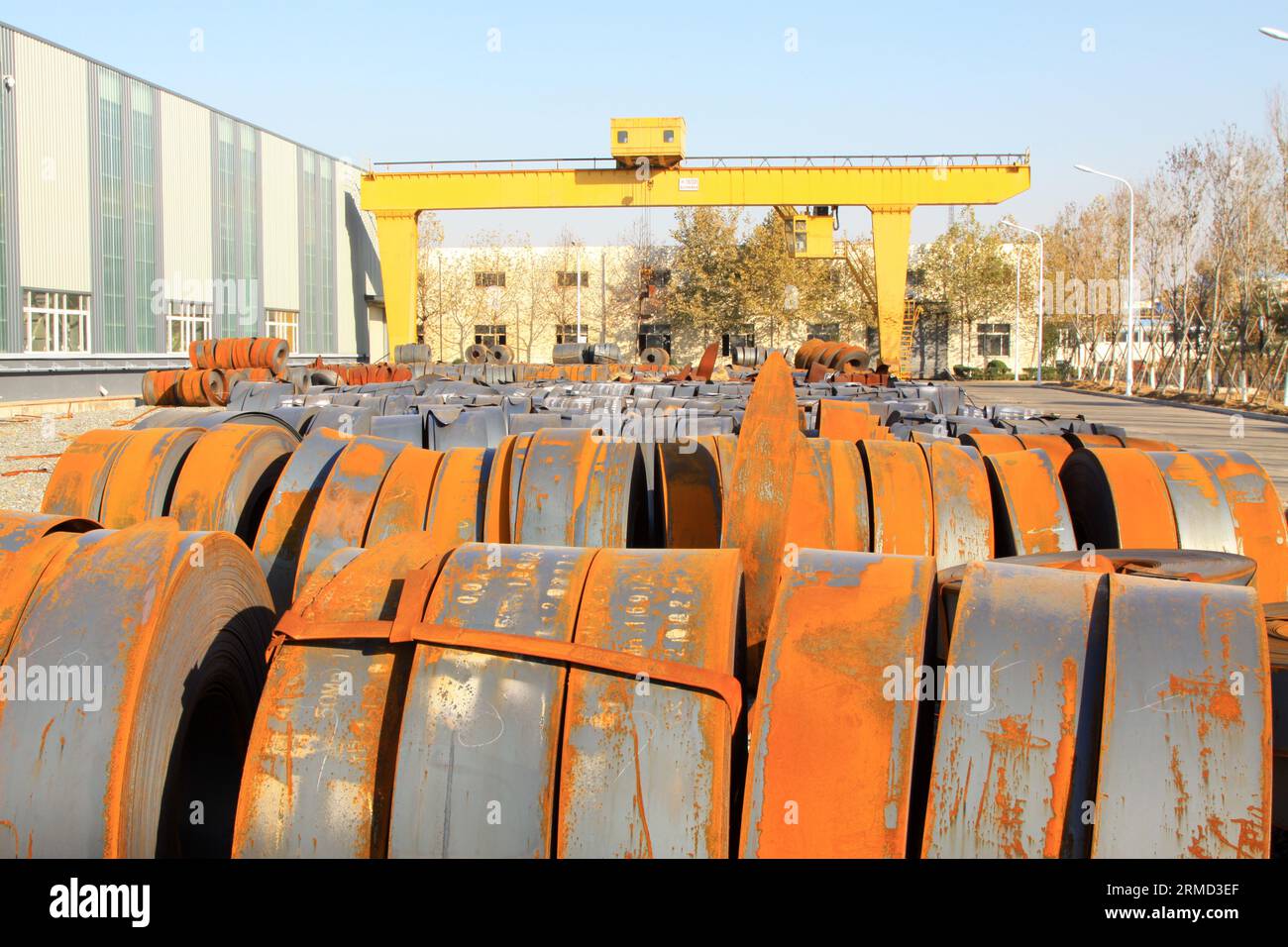 raw materials strip steel and crane, in a material field Stock Photo ...