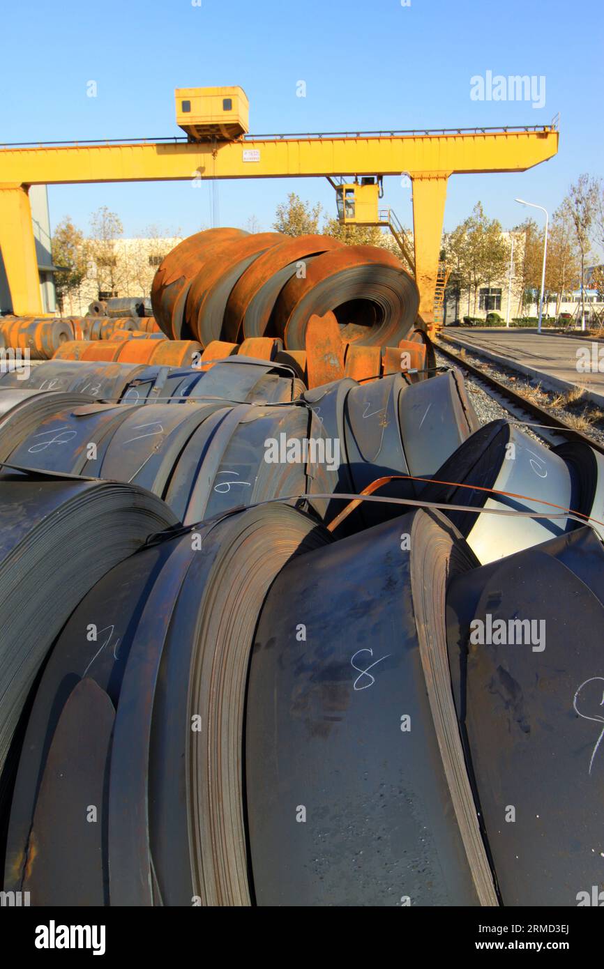 raw materials strip steel and crane, in a material field Stock Photo ...