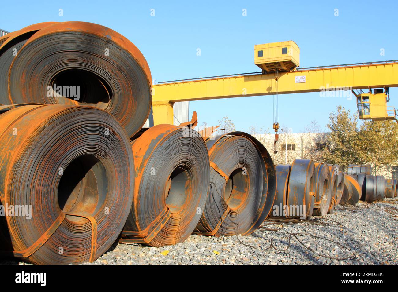 raw materials strip steel and crane, in a material field Stock Photo ...