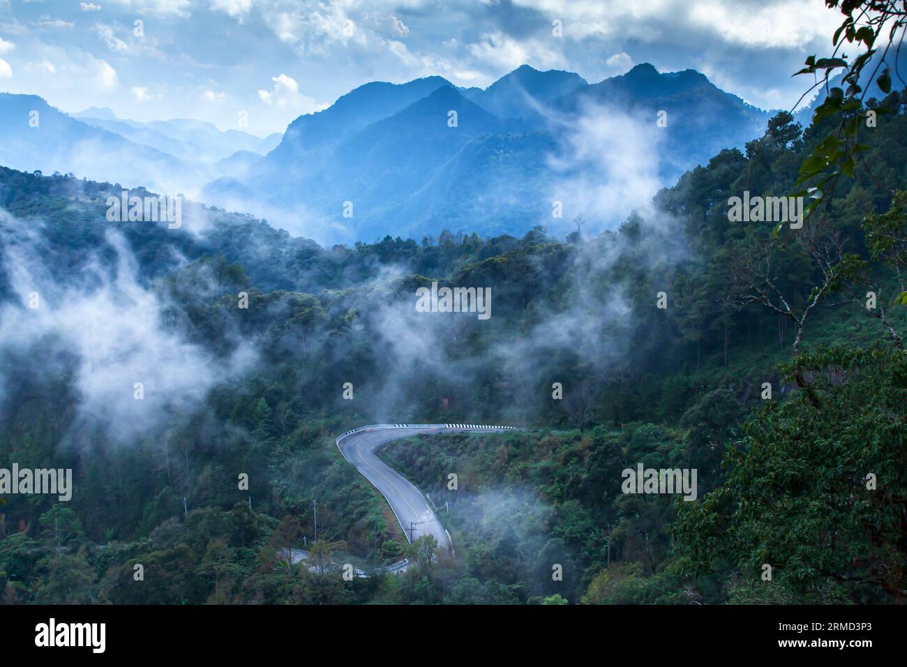 The scenery of the mountain road in the morning fog, the curved road ...