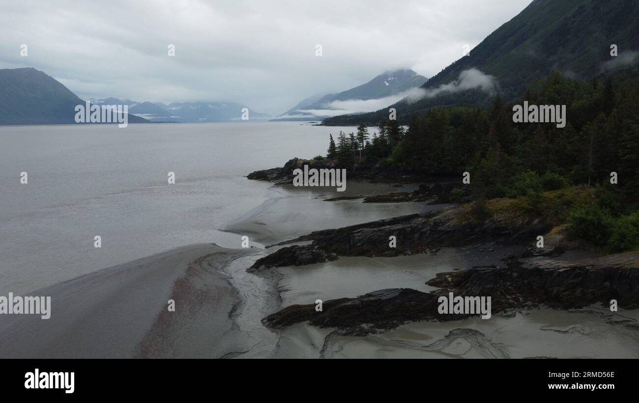 An aerial view of Turnagain Arm Cook Inlet, Alaska with a mountainous ...