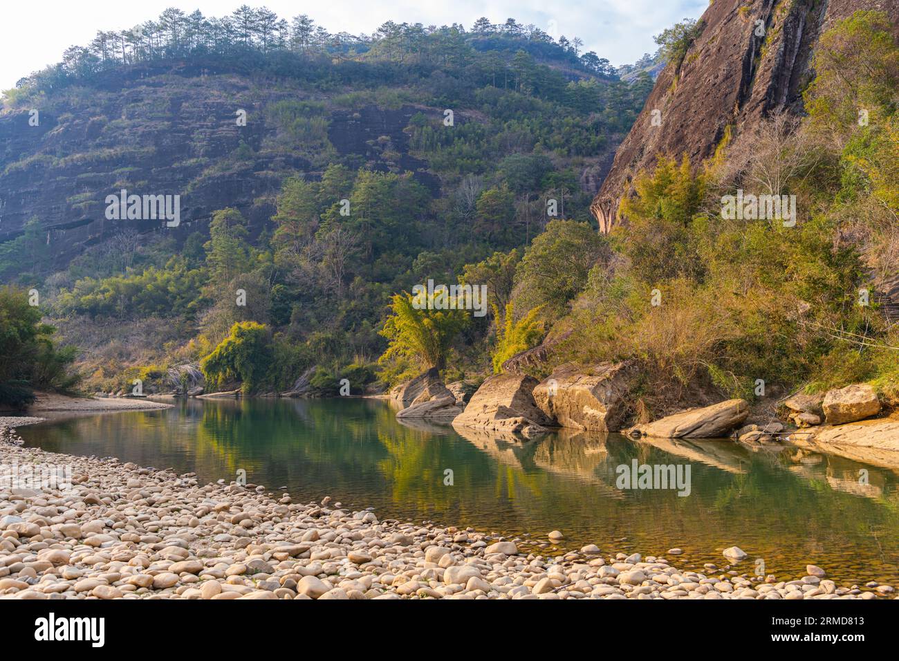 The emerald green water of the Nine Bend River or Jiuxi river through ...