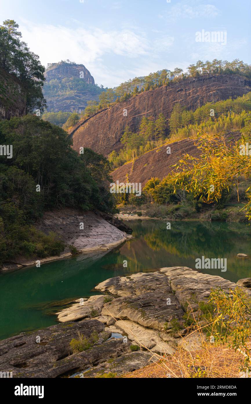 The emerald green water of the Nine Bend River or Jiuxi river through ...