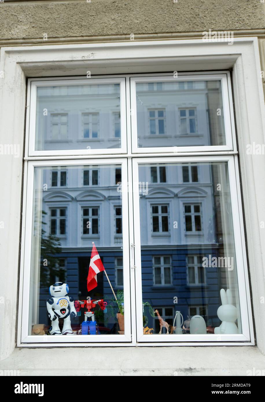 A Danish flag and decorations seen through a window of a house in ...