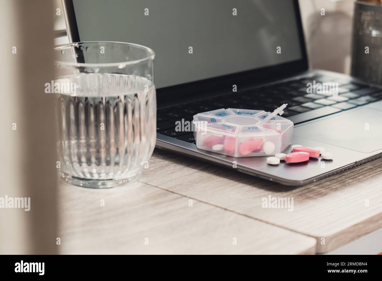 Organizer weekly shots with glass of water on workplace background and ...